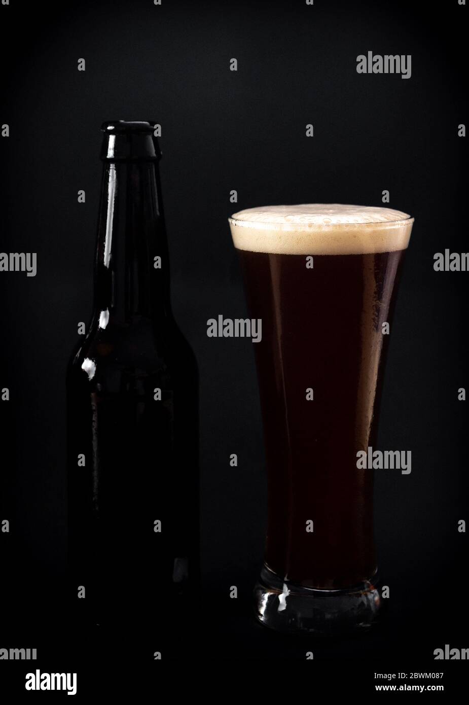 tasty irish red craft beer in glass with bottle next to it and black ...