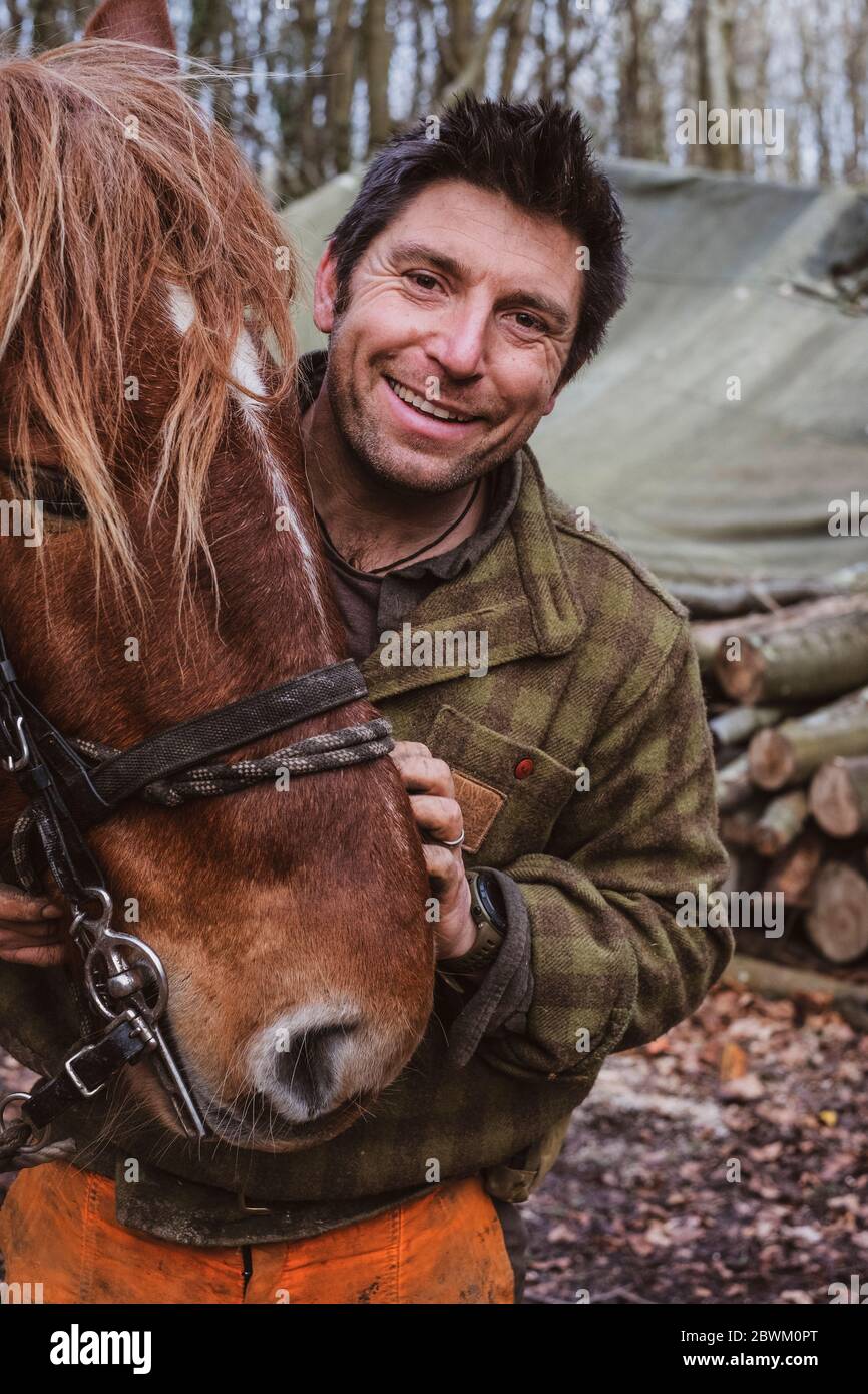 Portrait of a logger with one of his work horses Stock Photo - Alamy
