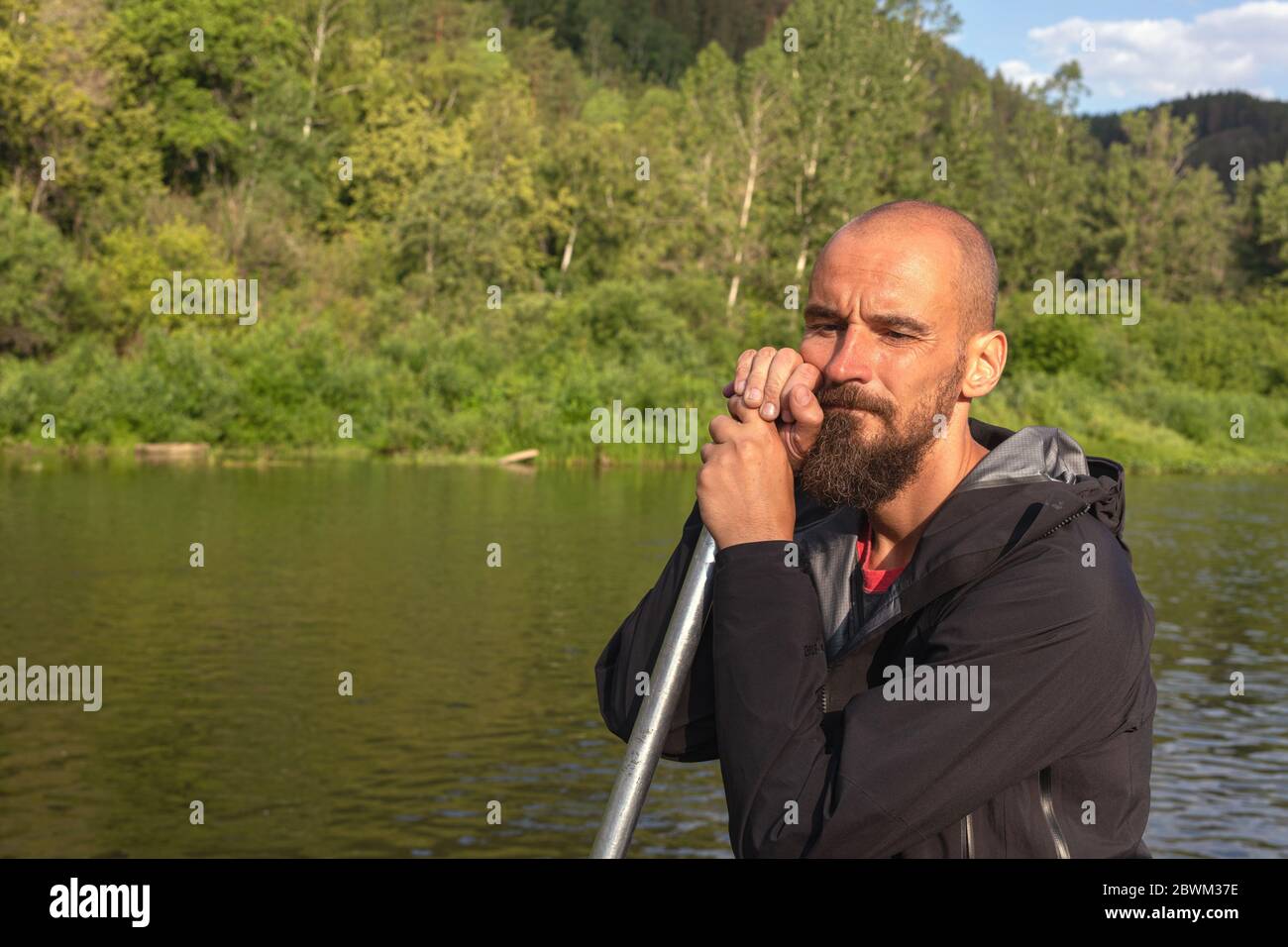 sunburnt bald, bearded men of 40 years with paddle on background of ...