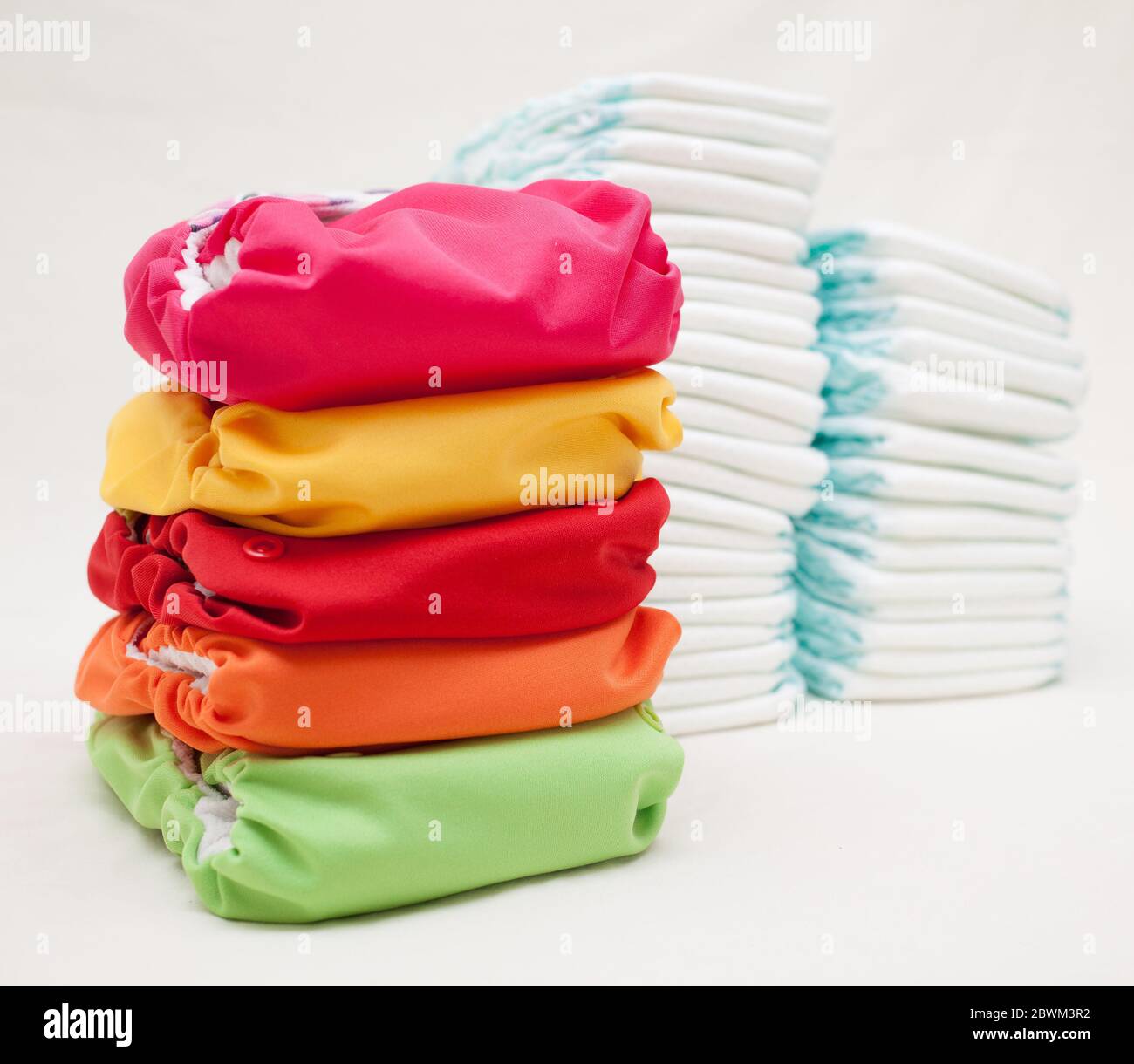 Stacks of disposable diapers and modern cloth diapers together Stock ...