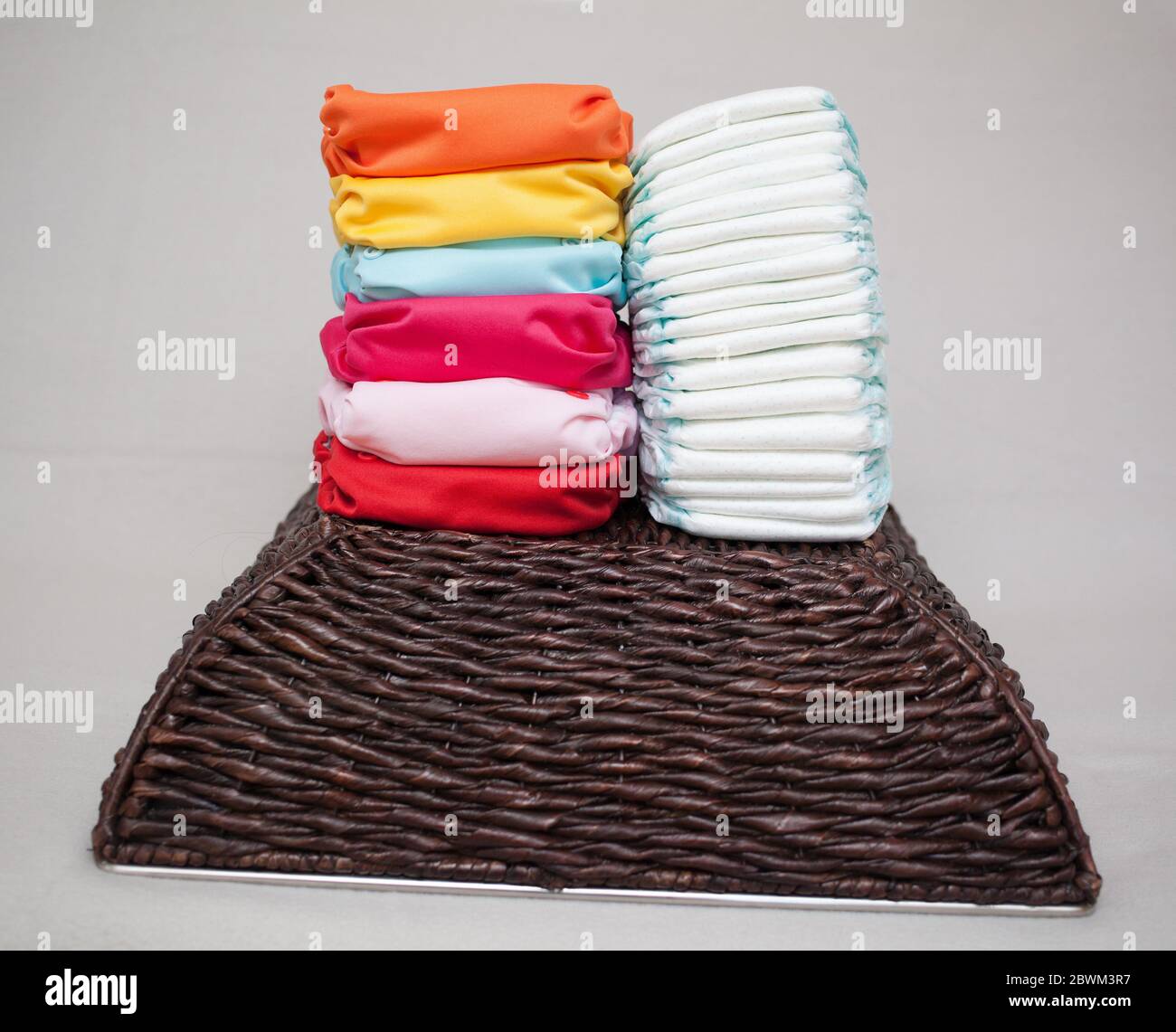 Stacks of disposable diapers and modern cloth diapers together Stock ...