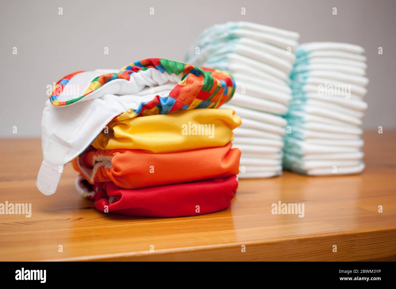 Stacks of disposable diapers and modern cloth diapers together Stock ...