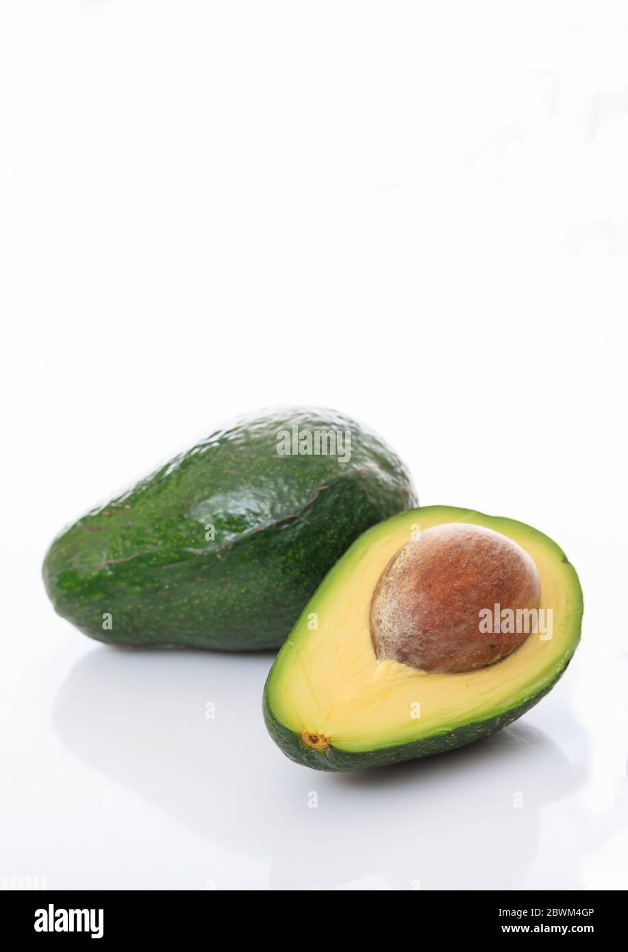 Healthy lifestyle concept. Avocados whole and half isolated on white ...