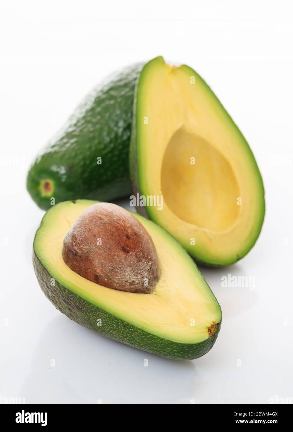 Healthy lifestyle concept. Avocados whole and half isolated on white ...