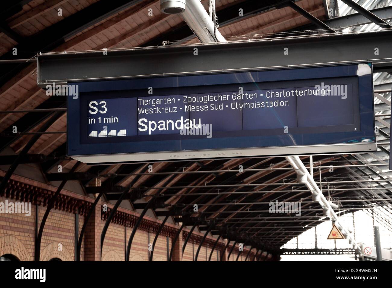 A train station sign showing the next train and its destinations on a ...