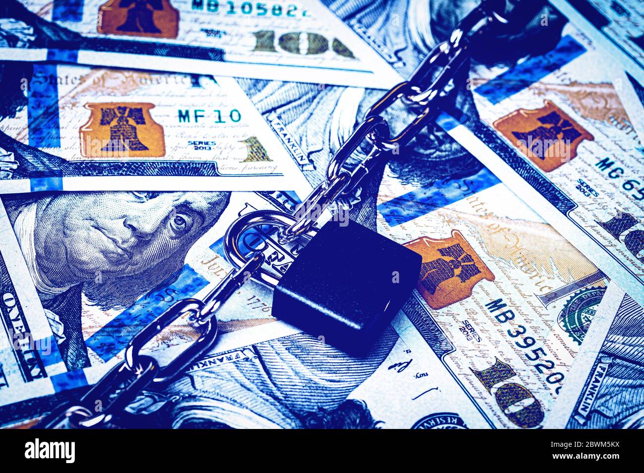 Dollar bills, black lock and metal chain. Money lock or security ...