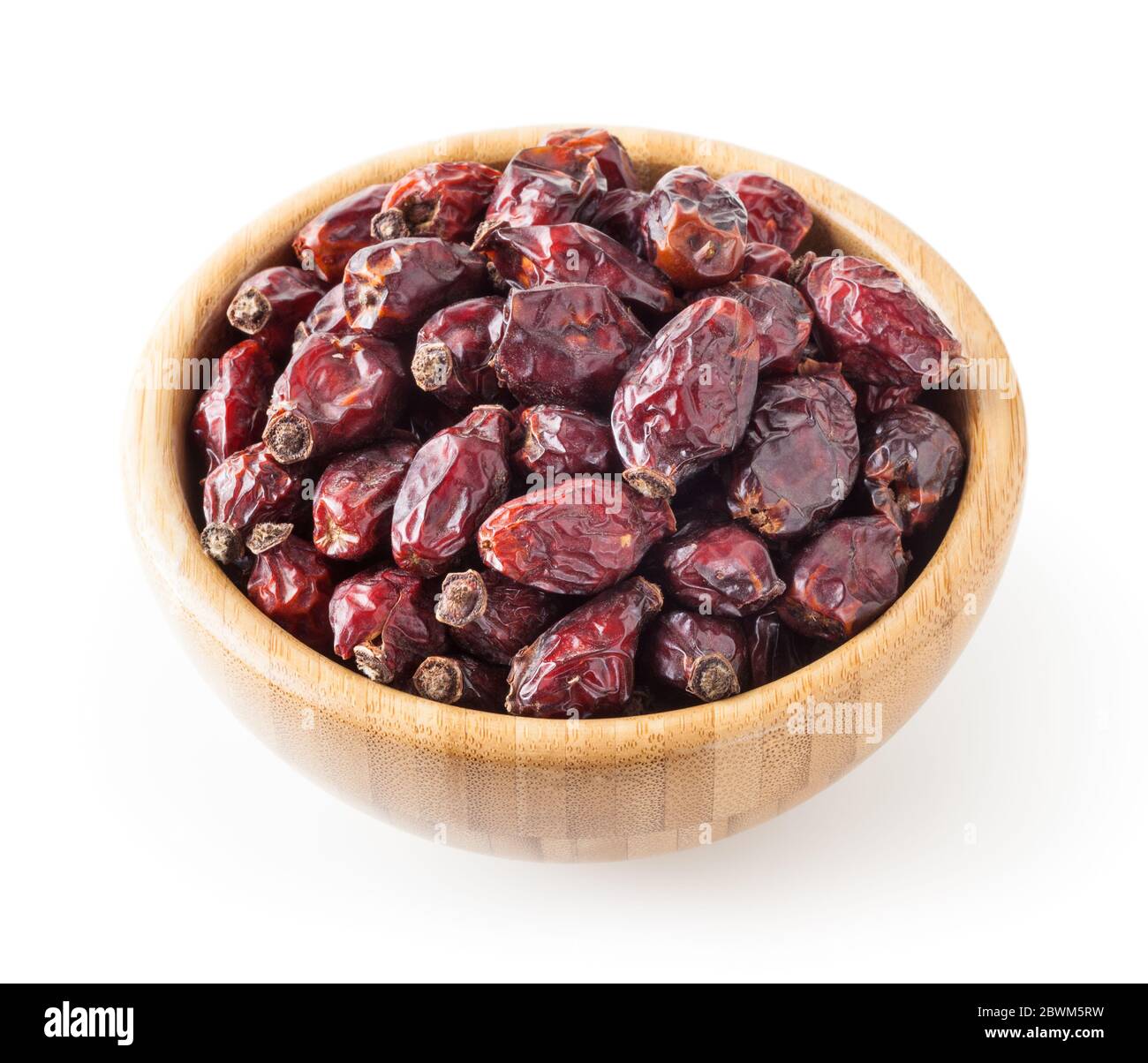 Dried wild rose berries in wooden bowl isolated on white background ...