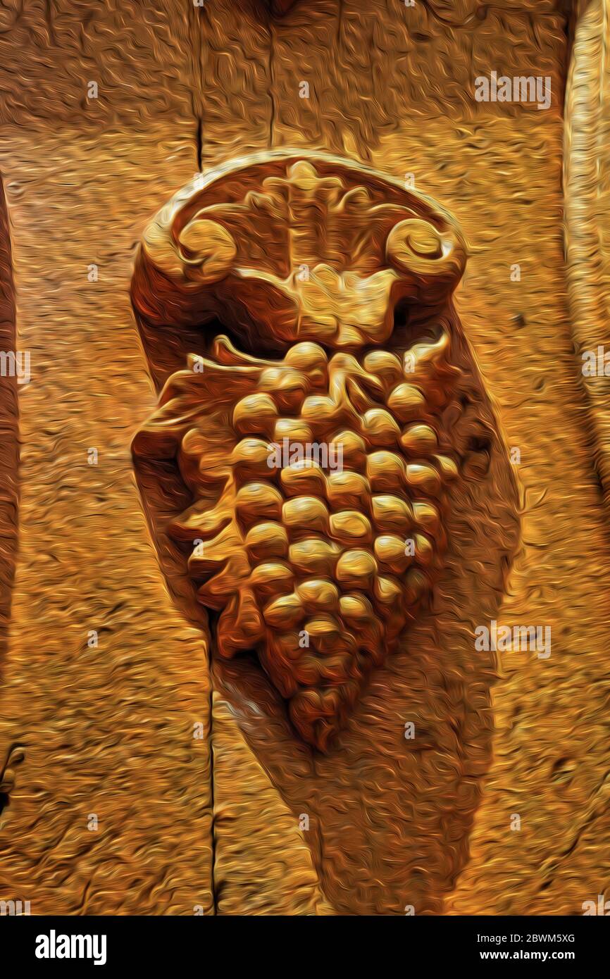 Close-up of grape-shaped wooden ornament on painted door in an old ...