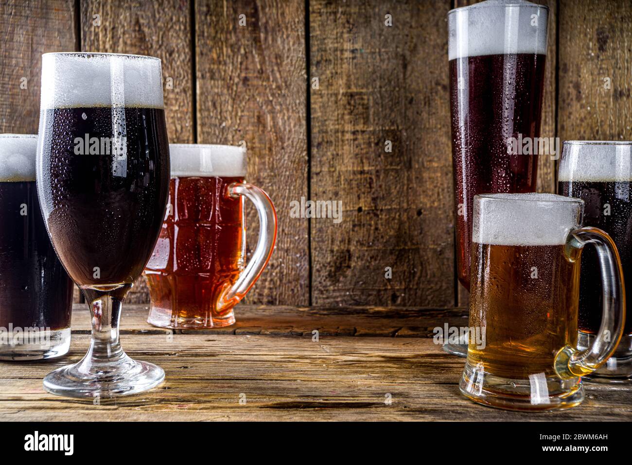 Different sorts of craft beer on wooden bar background. Set of various ...