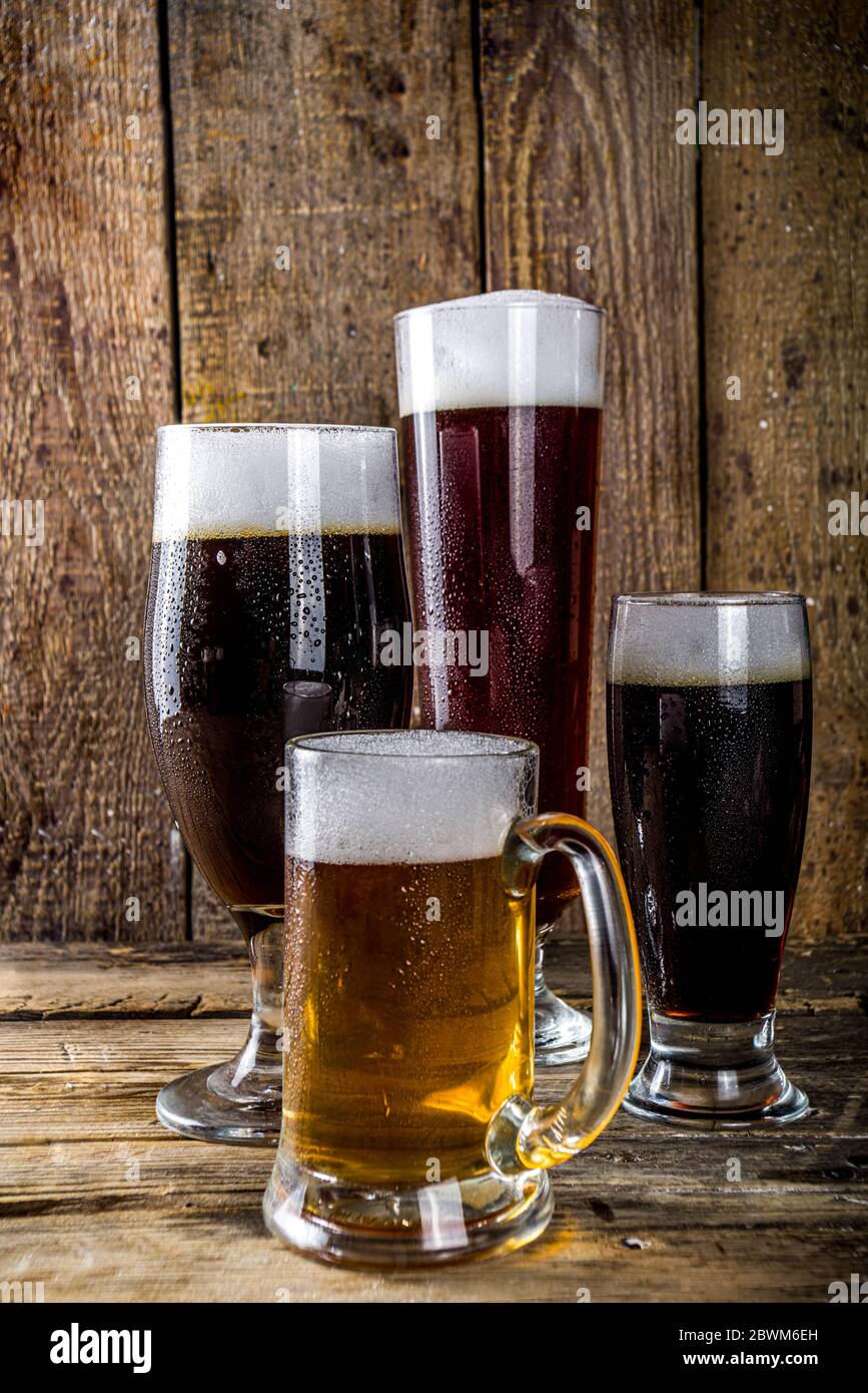 Different sorts of craft beer on wooden bar background. Set of various ...