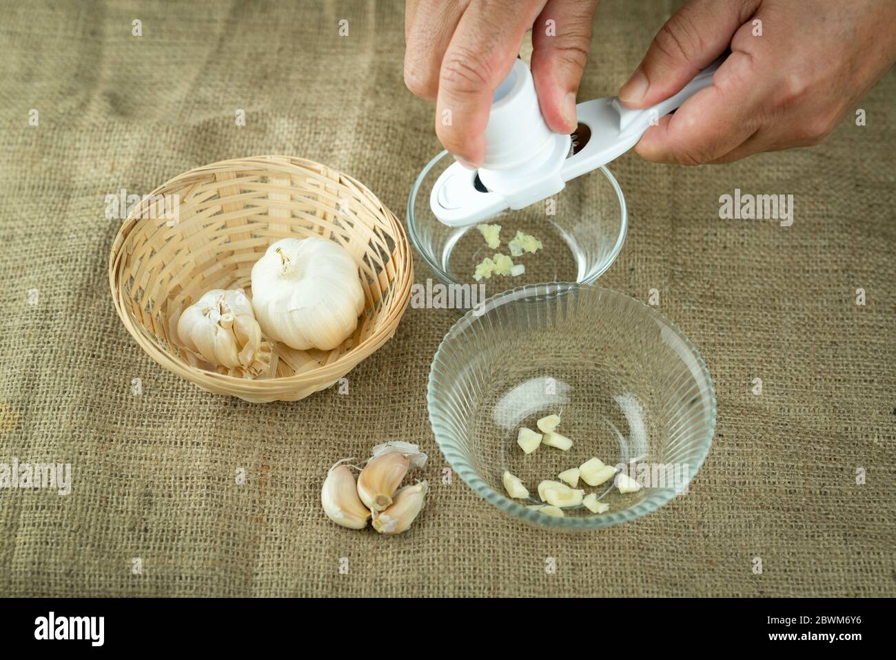 Hand holding grater to grate garlic Stock Photo - Alamy