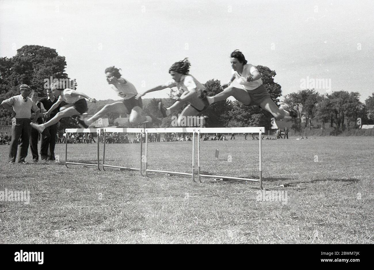 1950s, historical, summertime and a school sports day, four teenage ...