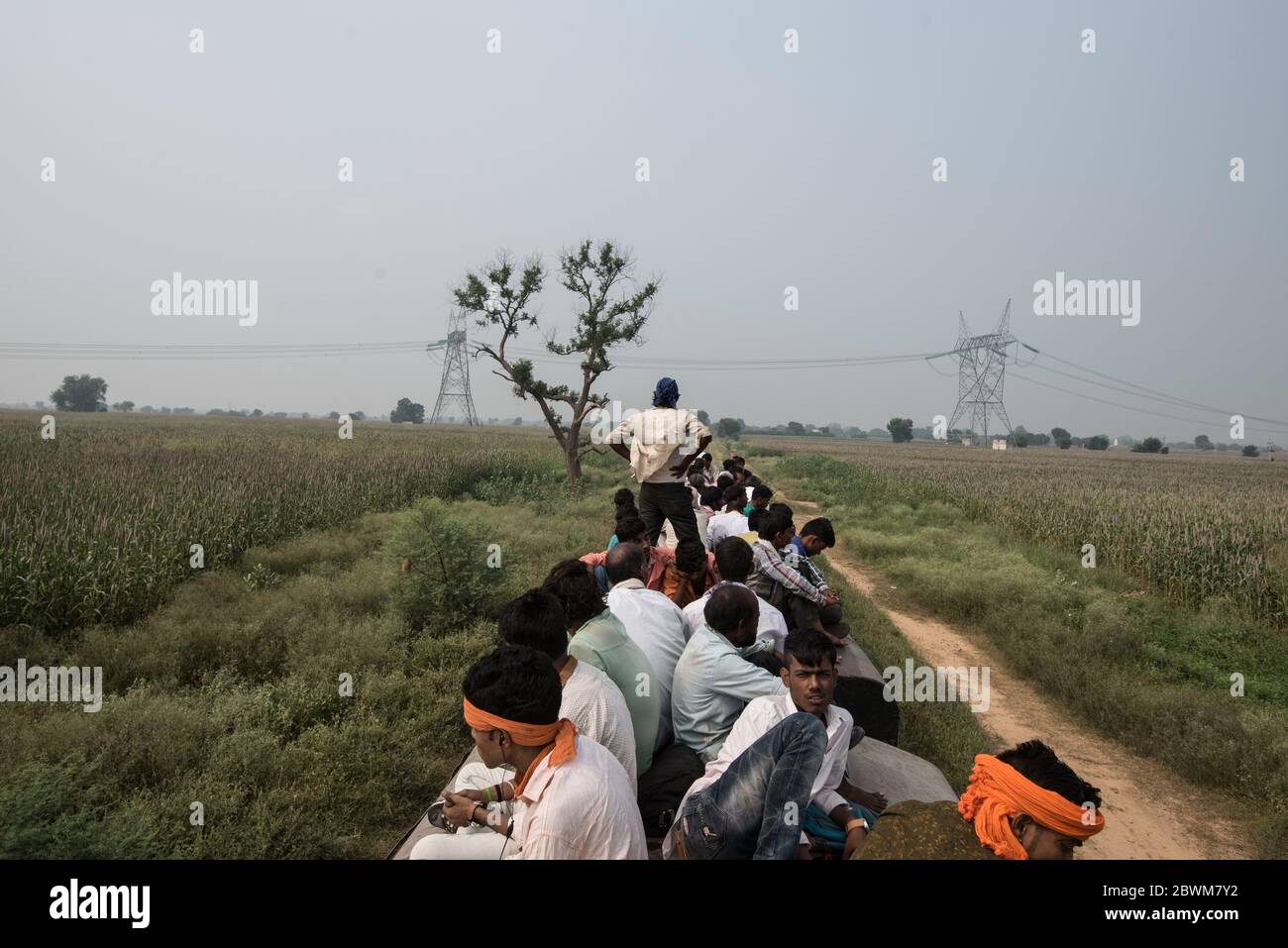 Men on top of overcrowded train passing through countryside in Madhya ...