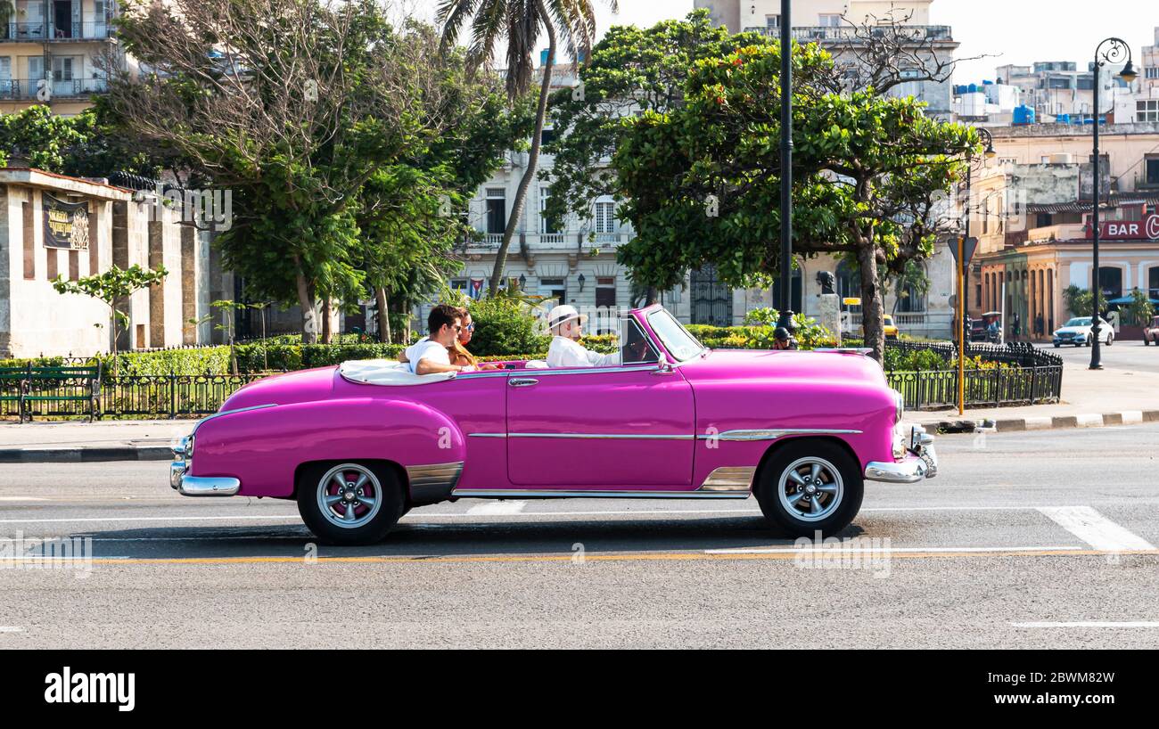 Havana, Cuba - 25 July 2018: A cuban taxi driver in his 1950s pink ...
