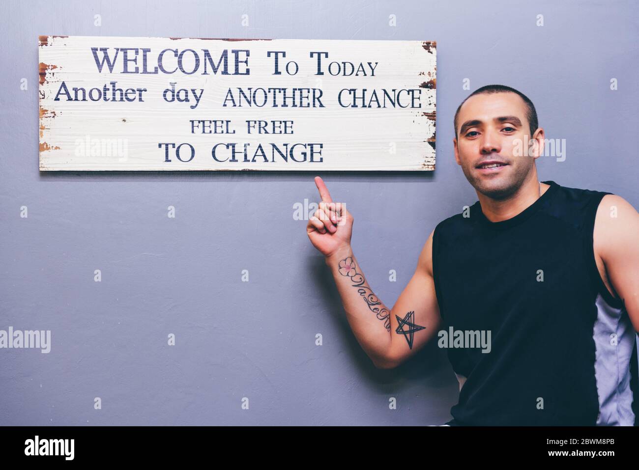 Latino boy pointing motivational poster in English on wall Stock Photo ...