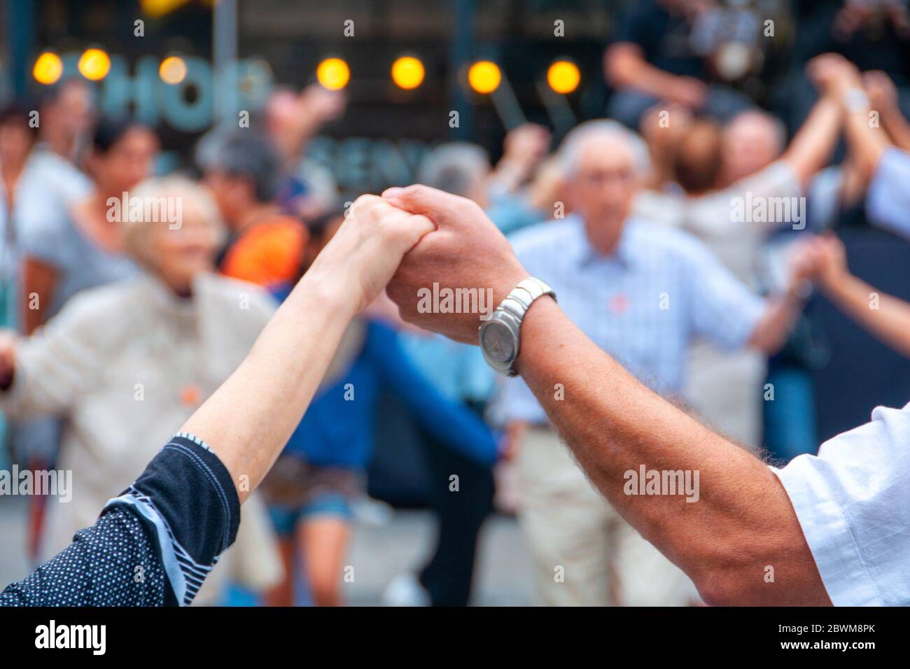 Barcelona, Spain. View of senior people holding hands and dancing ...