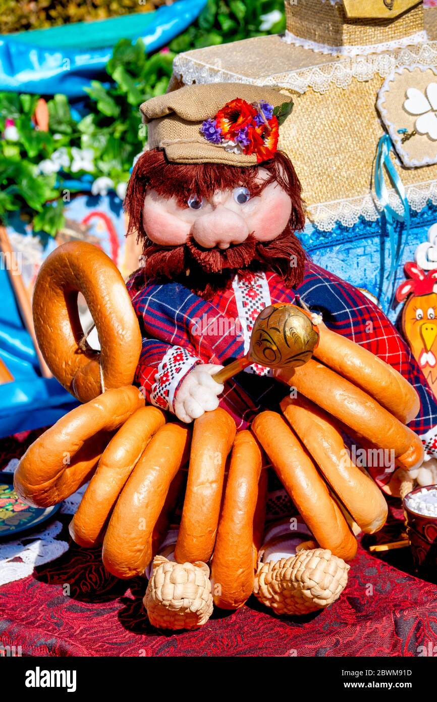 Stuffed doll holding traditional Shushki (Sweed bread rings Stock Photo ...