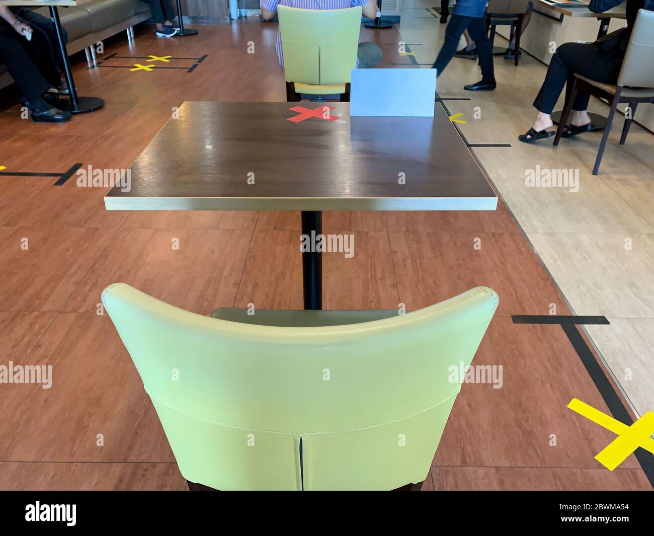New normal red cross sign on dining table to make social distancing for ...