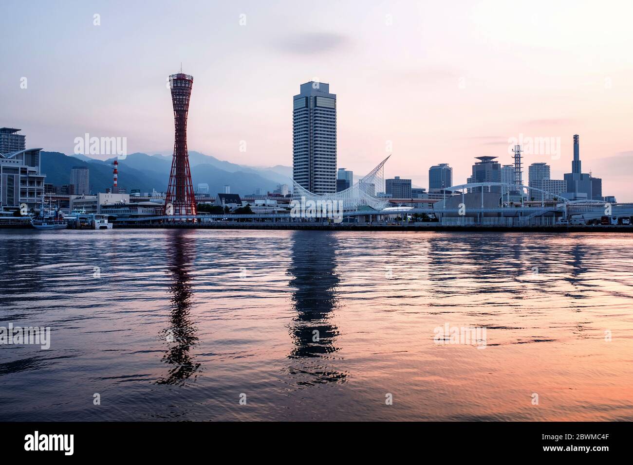 Kobe, Japan. View of sunrise in Kobe, Japan. Cloudless sky with harbor ...