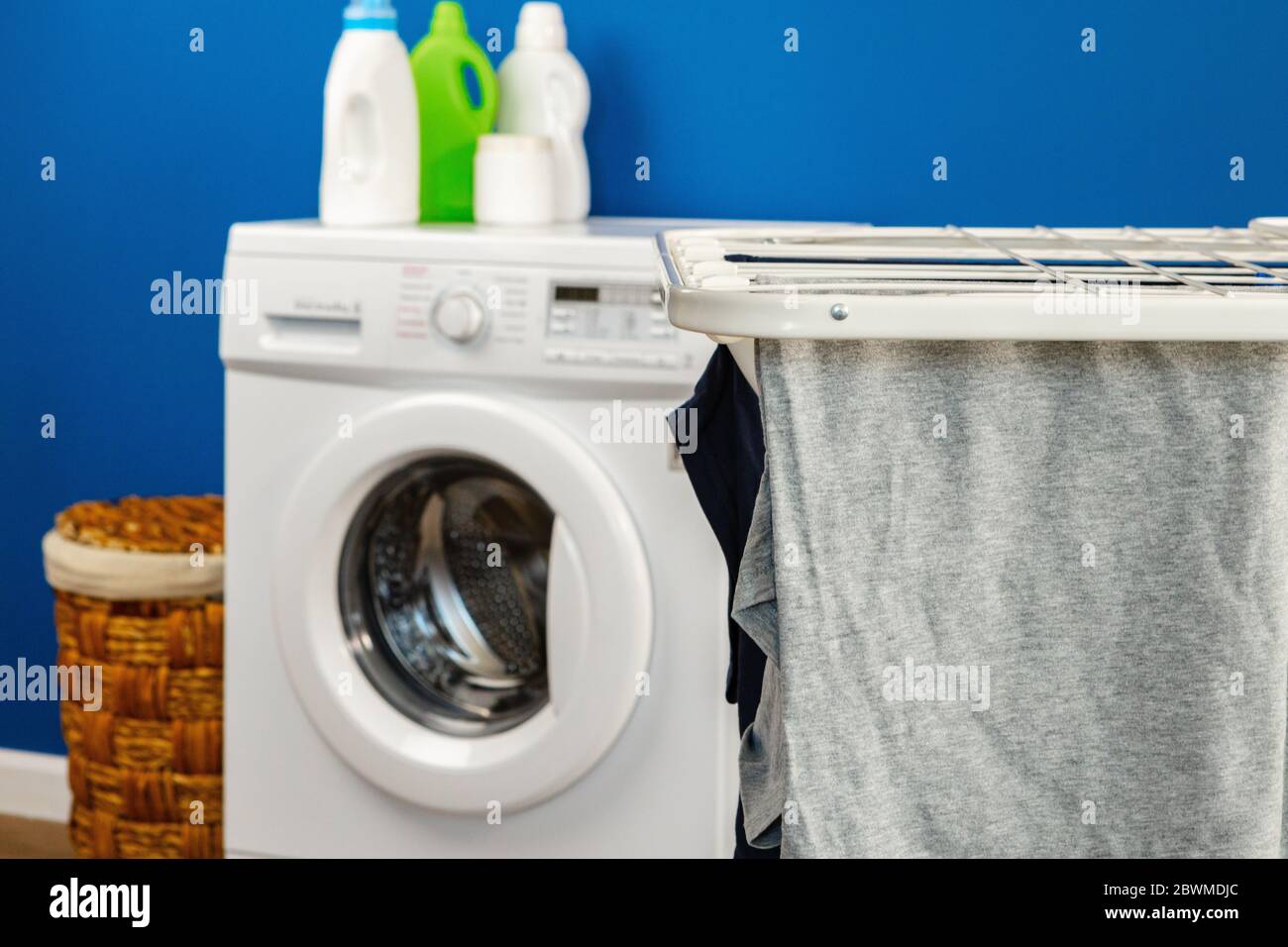 Laundry room interior with washing machine and clothes dryer near wall ...