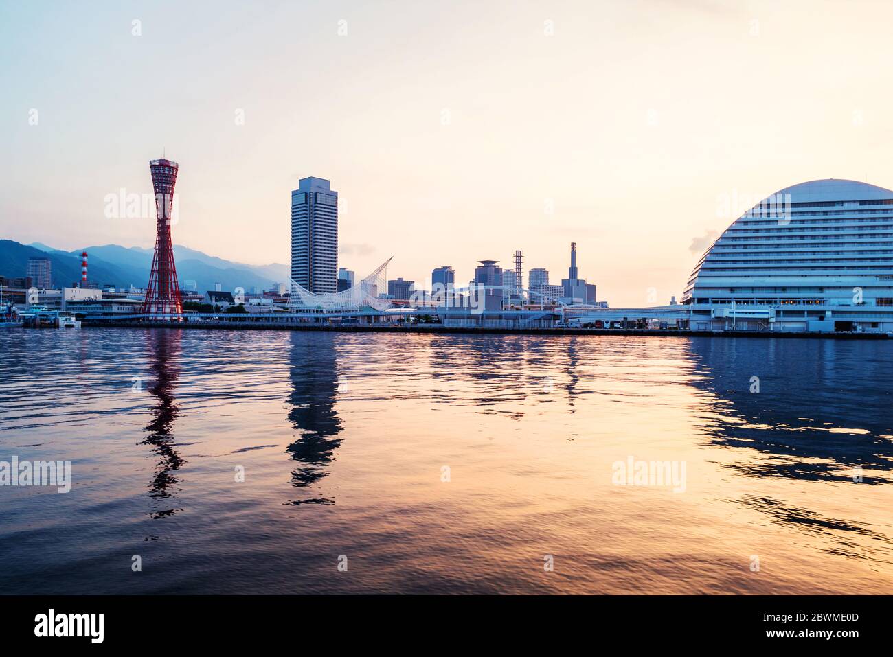 Kobe, Japan. View of sunrise in Kobe, Japan. Cloudless sky with harbor ...