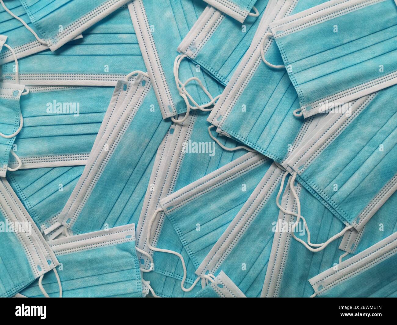 Blue disposable surgical masks background Stock Photo - Alamy