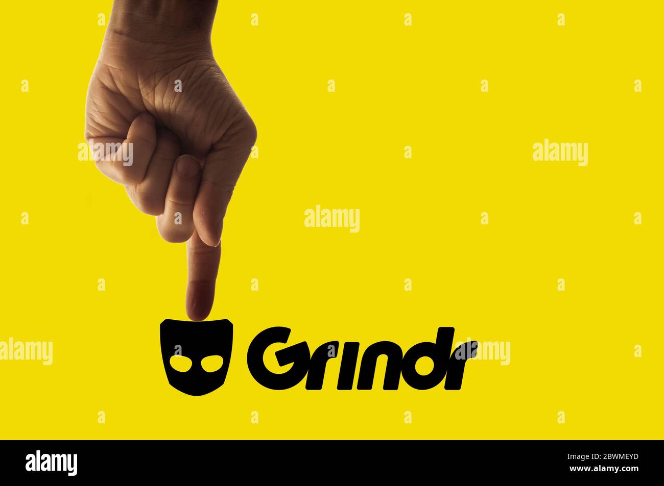 hand touching a Grindr logo Stock Photo - Alamy