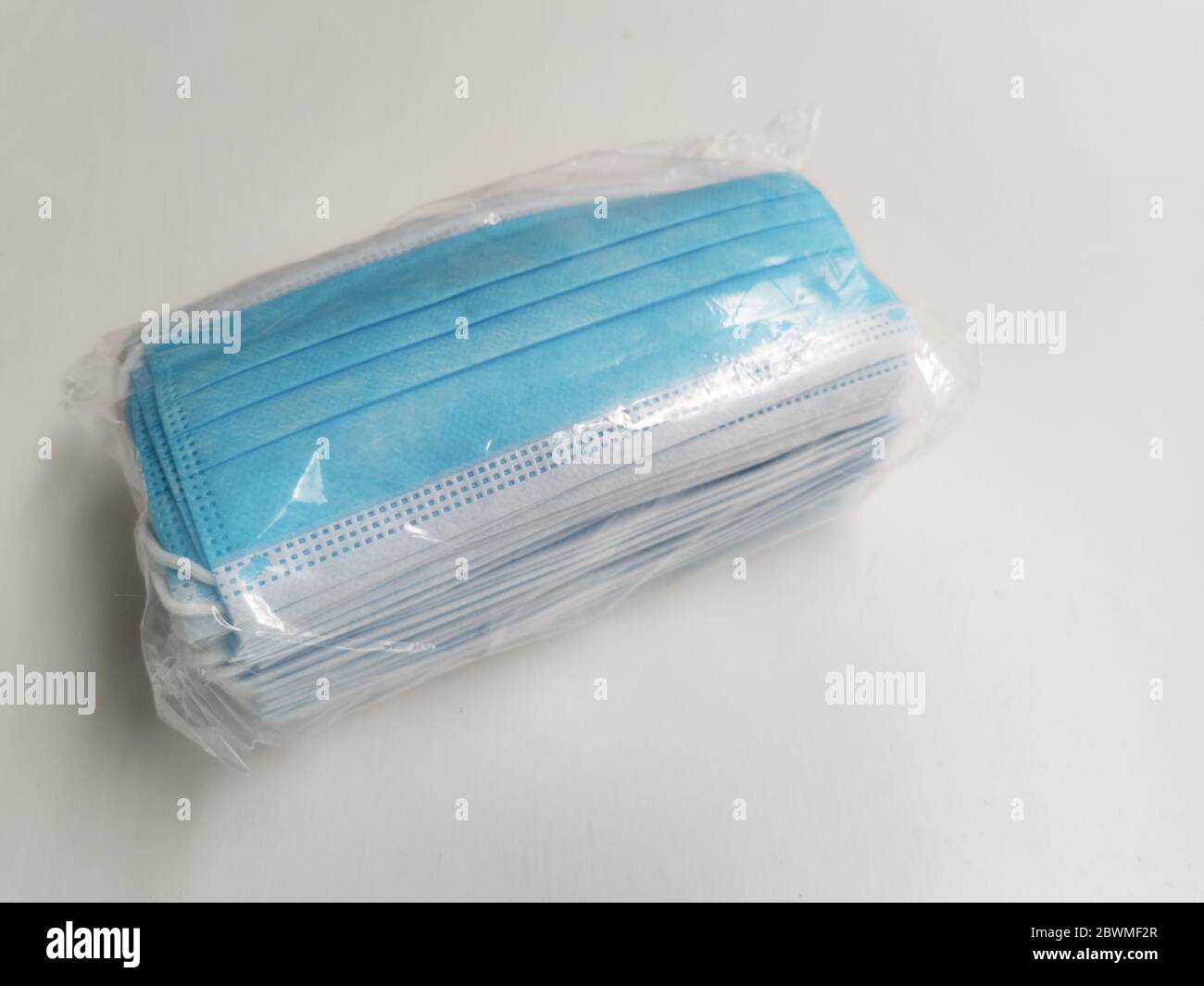 Pack of blue disposable surgical face mask on a white background Stock ...