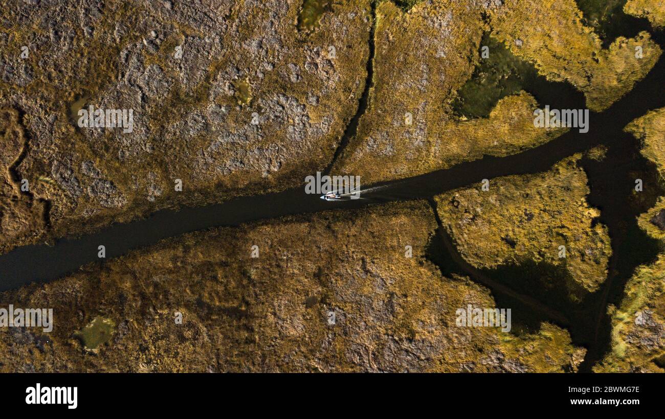 Aerial top-down view on motor speed boat rushing through pathways ...