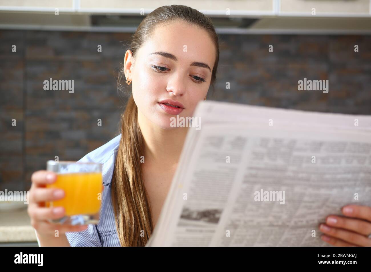 Young pretty woman reading newspaper hi-res stock photography and images - Alamy