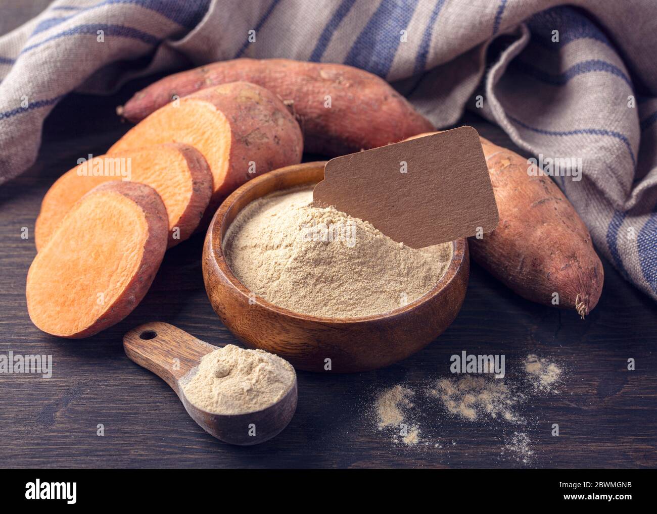 Sweet potato flour in a wooden bowl isolated on a white background ...