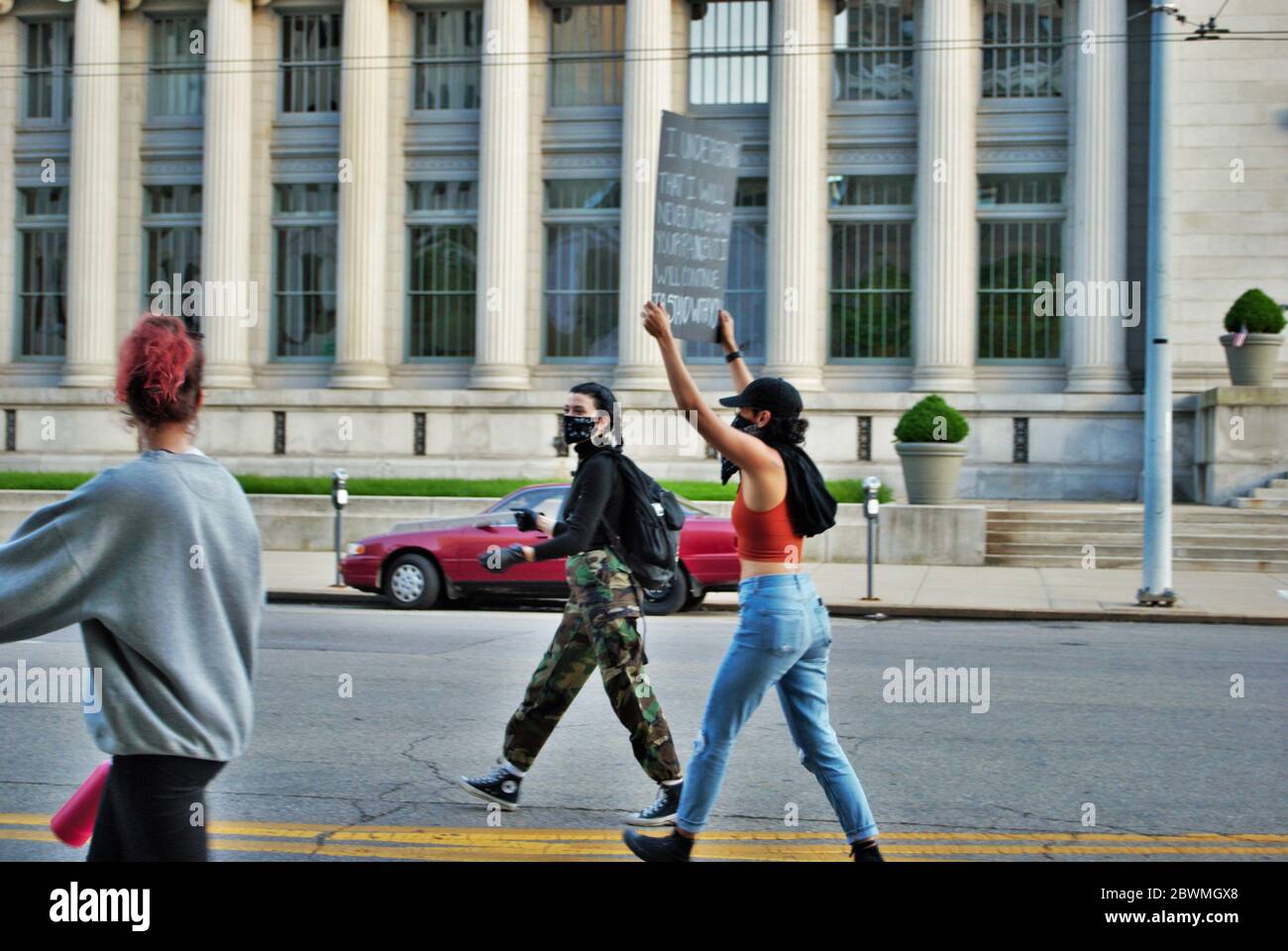 Protesters walking down the middle of a city street Stock Photo - Alamy