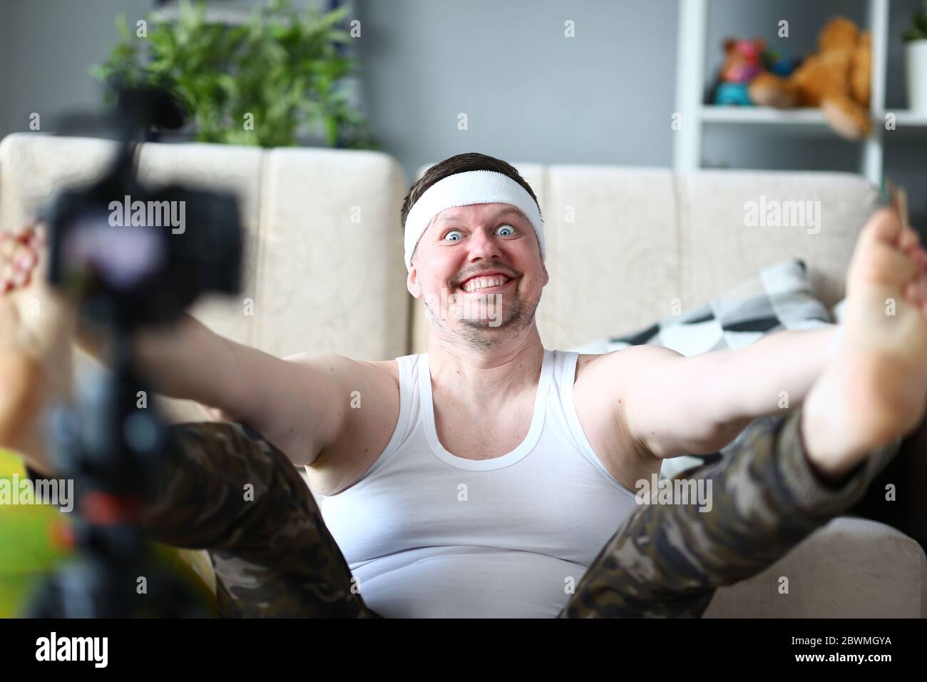 Positive delighted young man doing morning exercise Stock Photo - Alamy