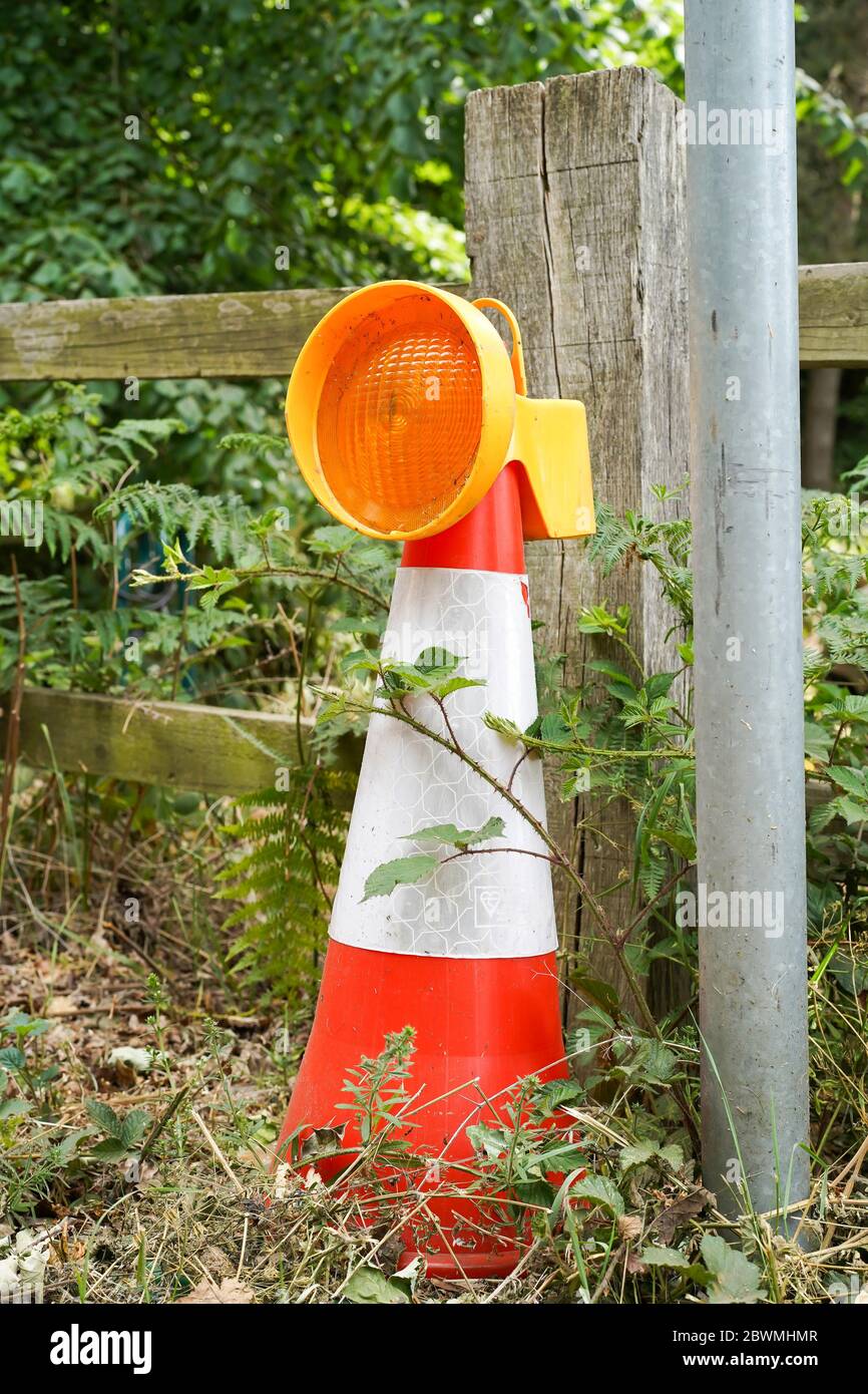 Close up of isolated road traffic cone with yellow flashing light ...
