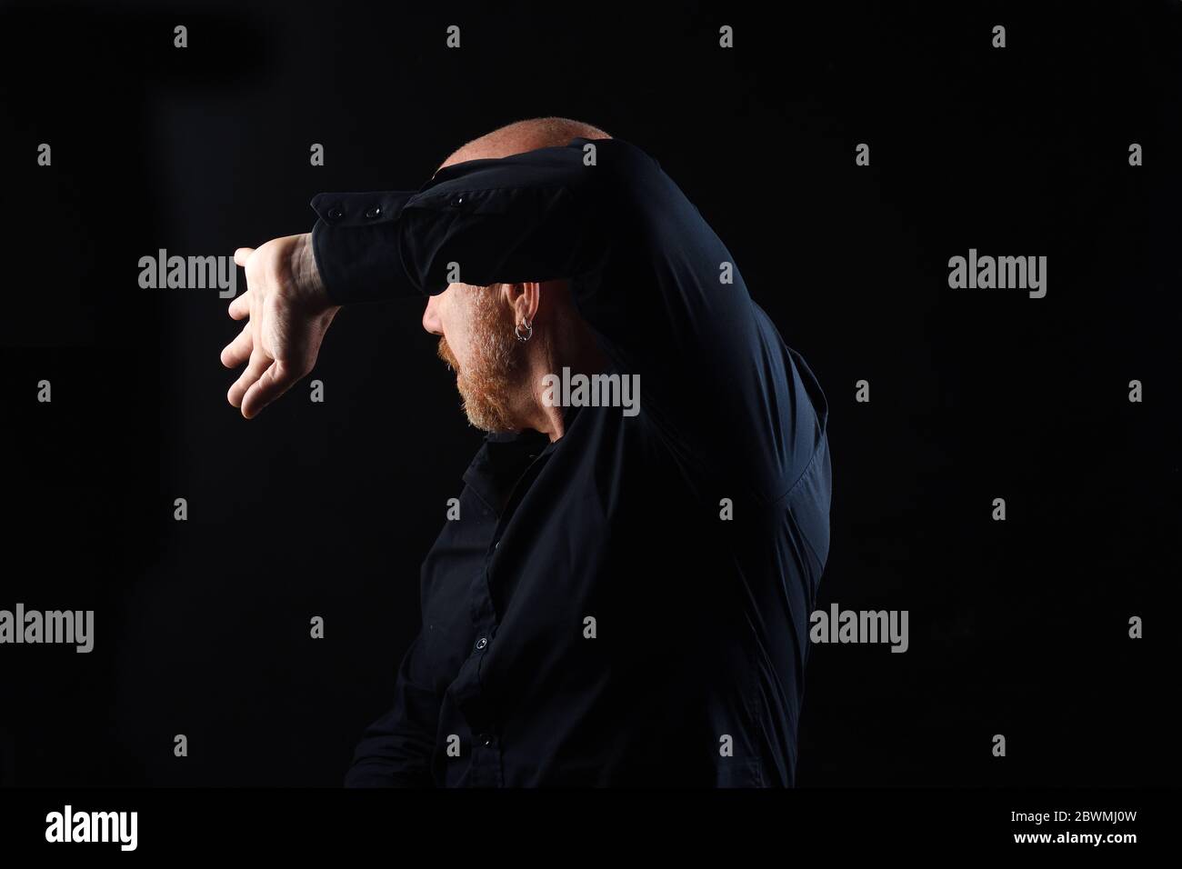 man protecting himself with his arm raised Stock Photo - Alamy