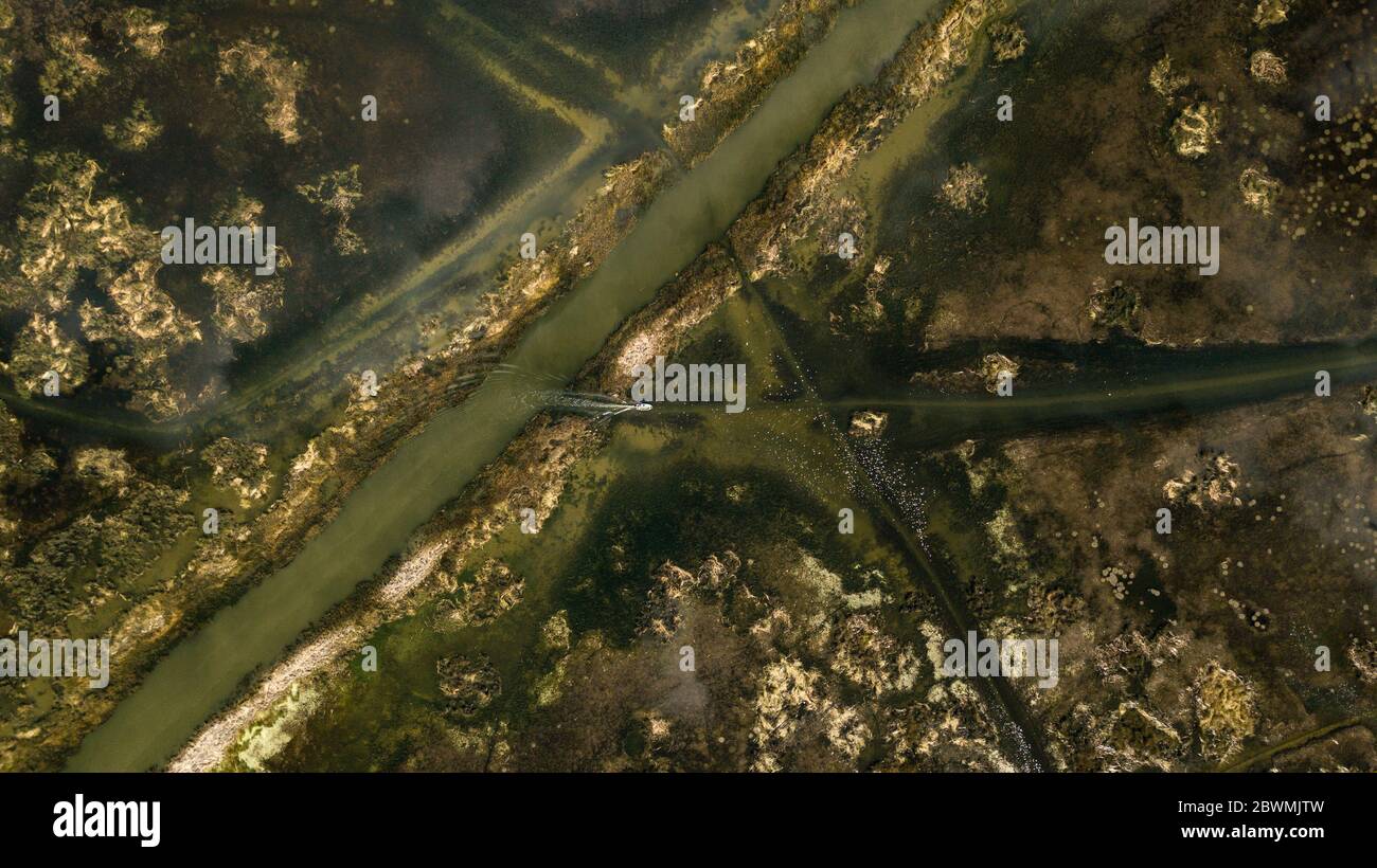 Aerial top-down view on motor speed boat rushing through pathways ...