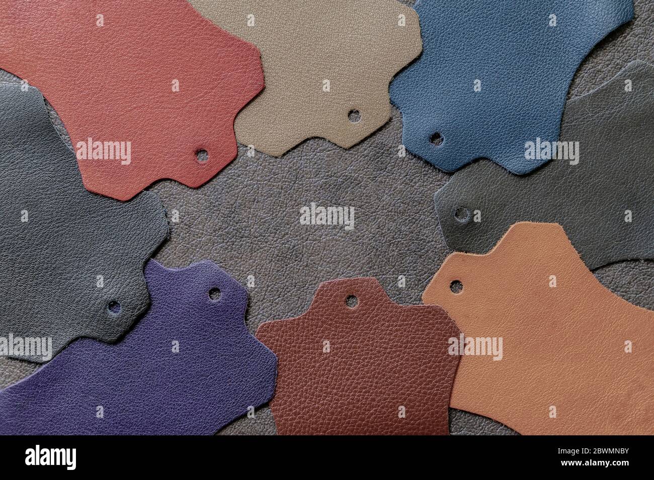 Multicolored leather samples on dark leather, abstract background ...