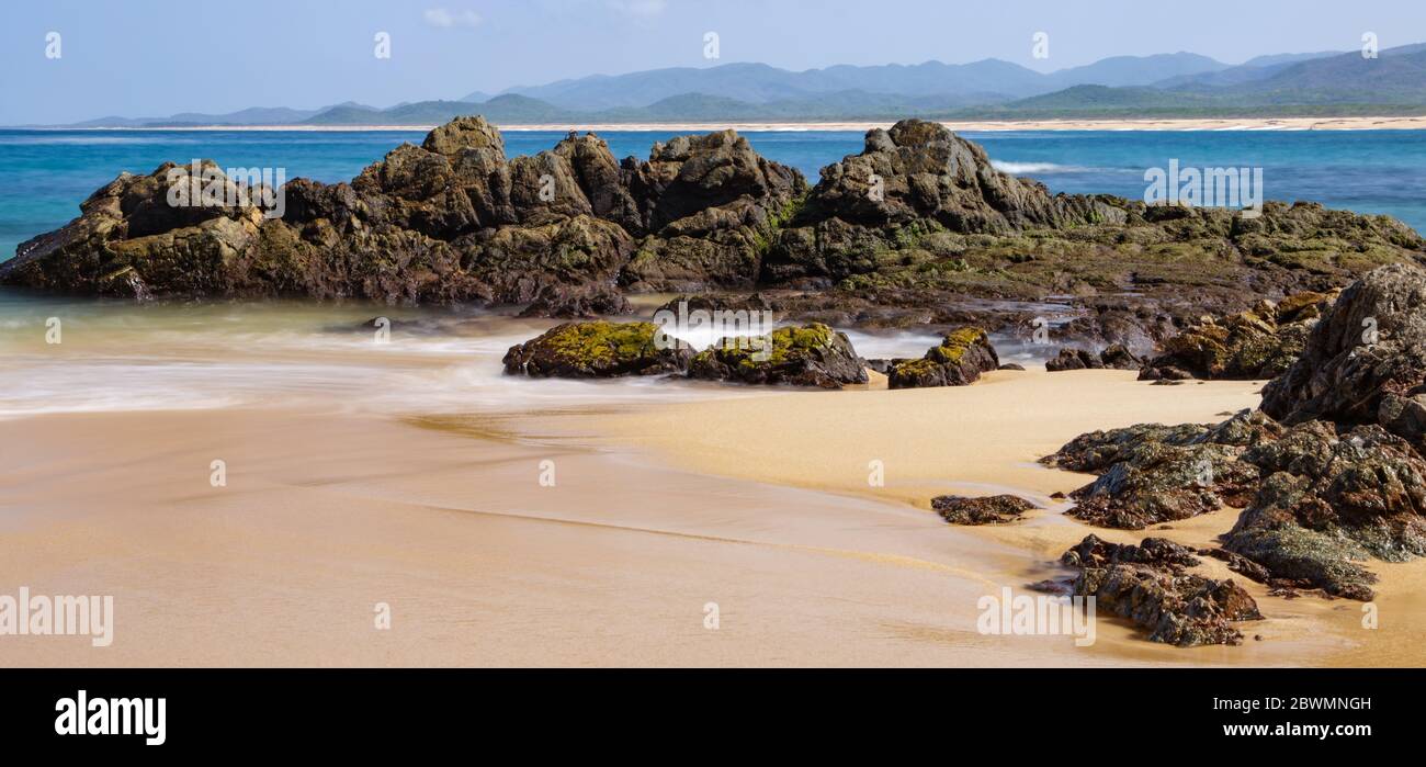 The beautiful wet sand and rocks covered in algae. Playa Mayto in ...