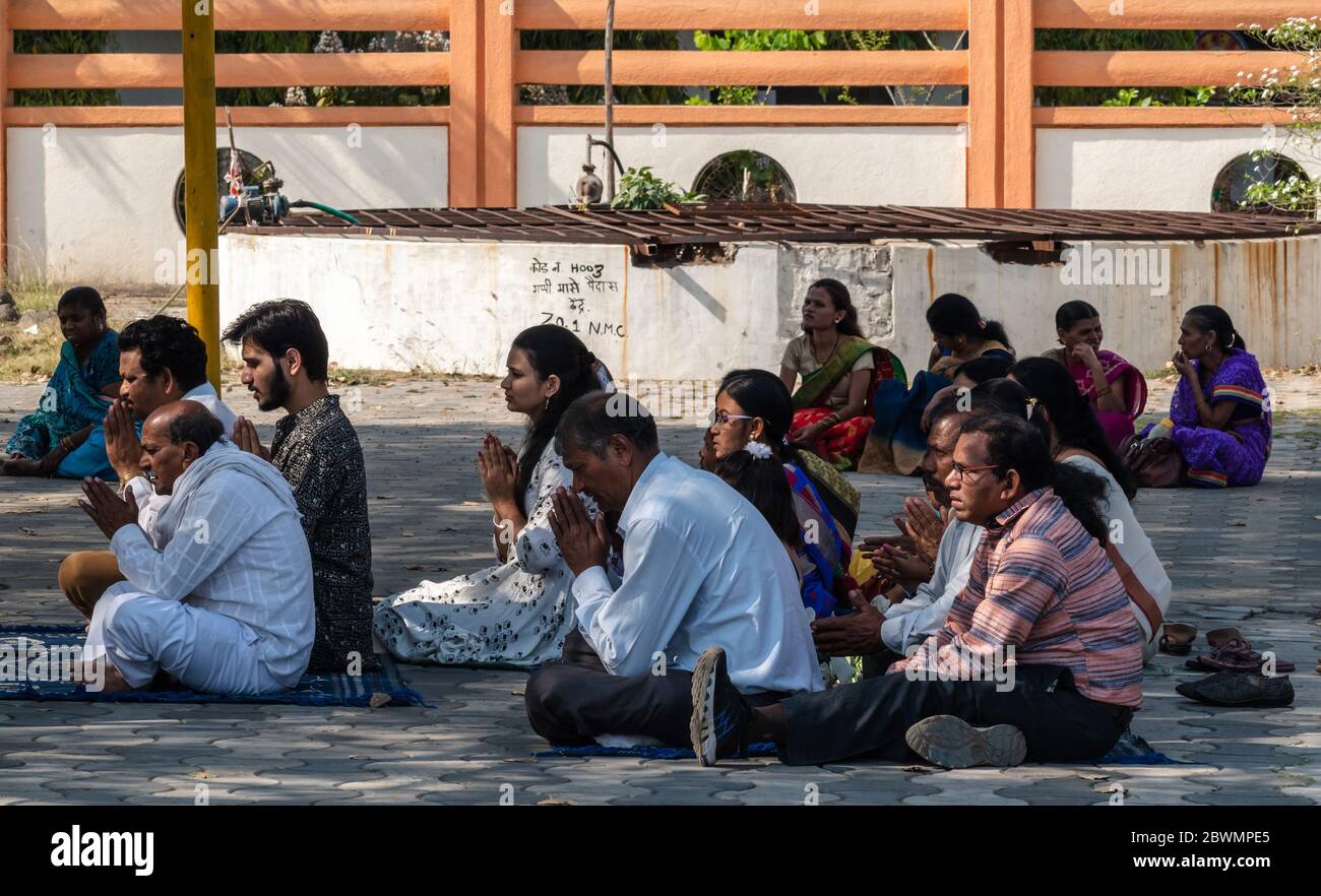 Nagpur, Maharashtra, India - March 2019: A group of Indian pilgrims sit ...