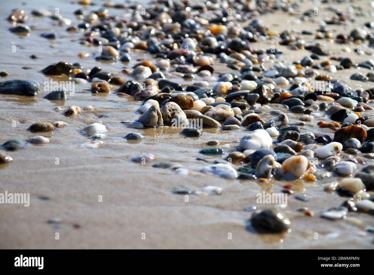 Sea beach with small rocks, close up Stock Photo - Alamy