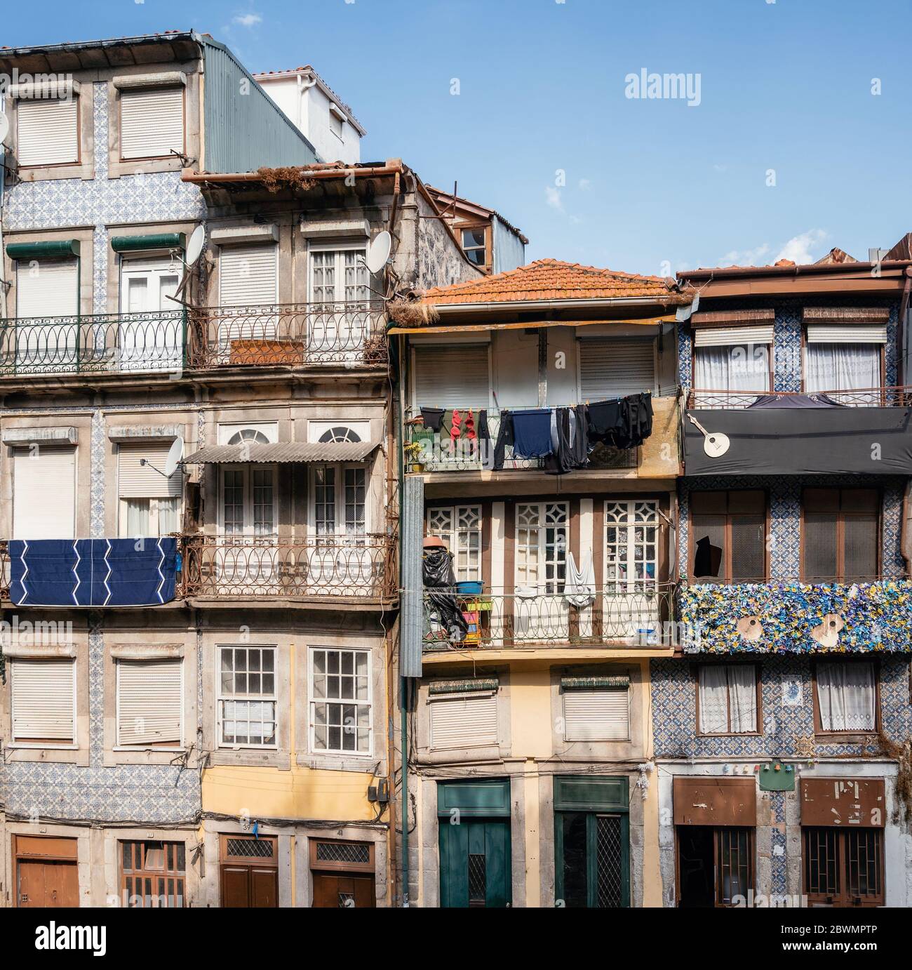 Traditional Portuguese house, with windows and ornate metal balcony ...