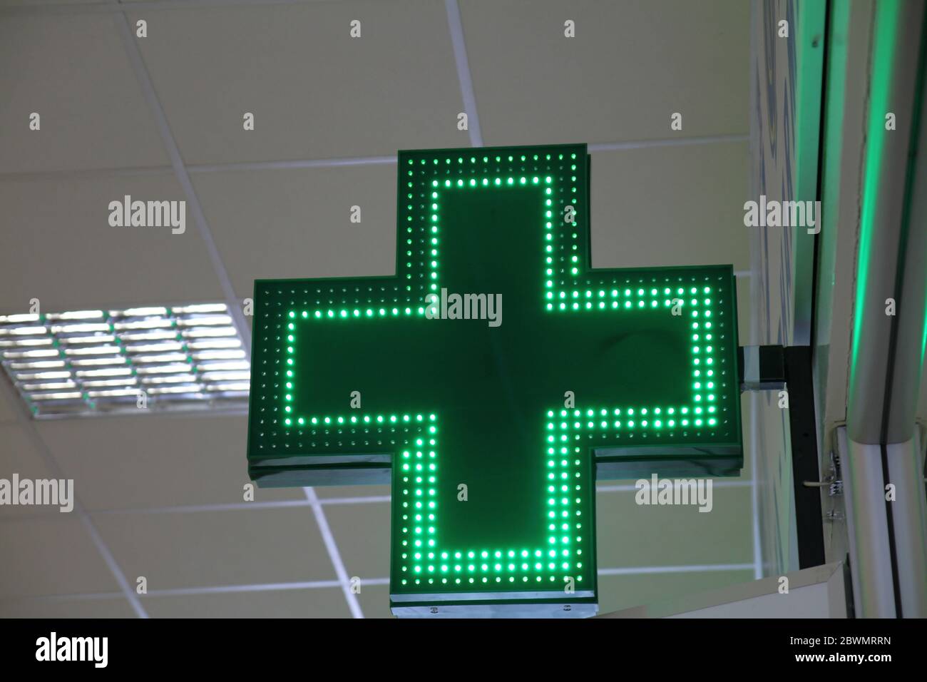 green led light cross symbol for a pharmacy Stock Photo - Alamy