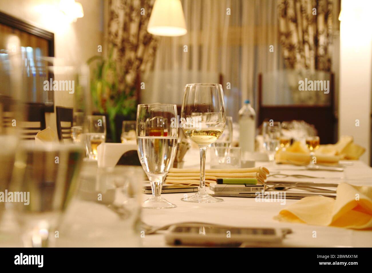 restaurant with dining table and glass cups Stock Photo - Alamy