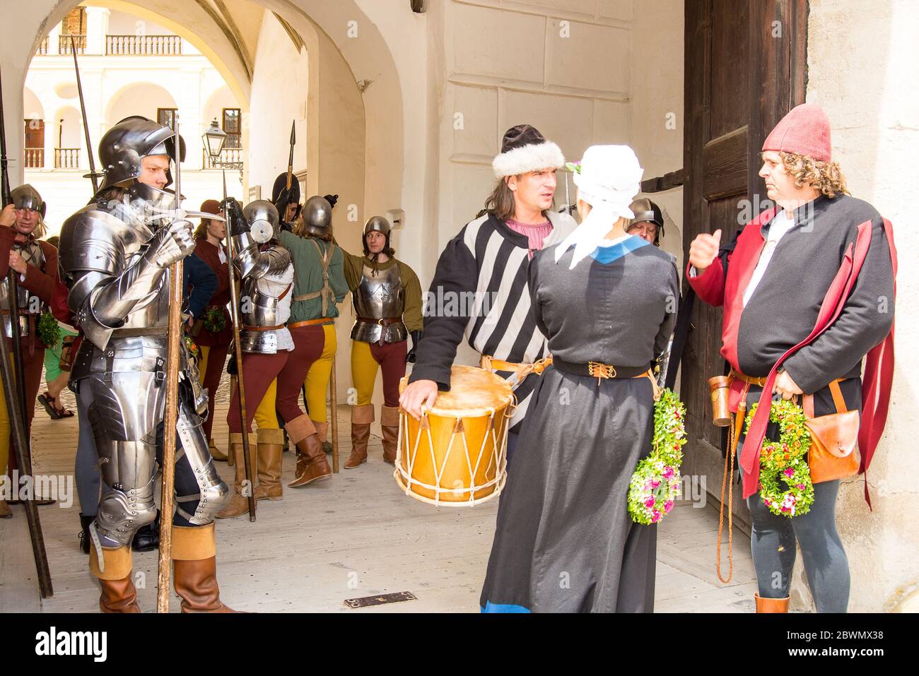 A group of people talk inside the castle Stock Photo - Alamy