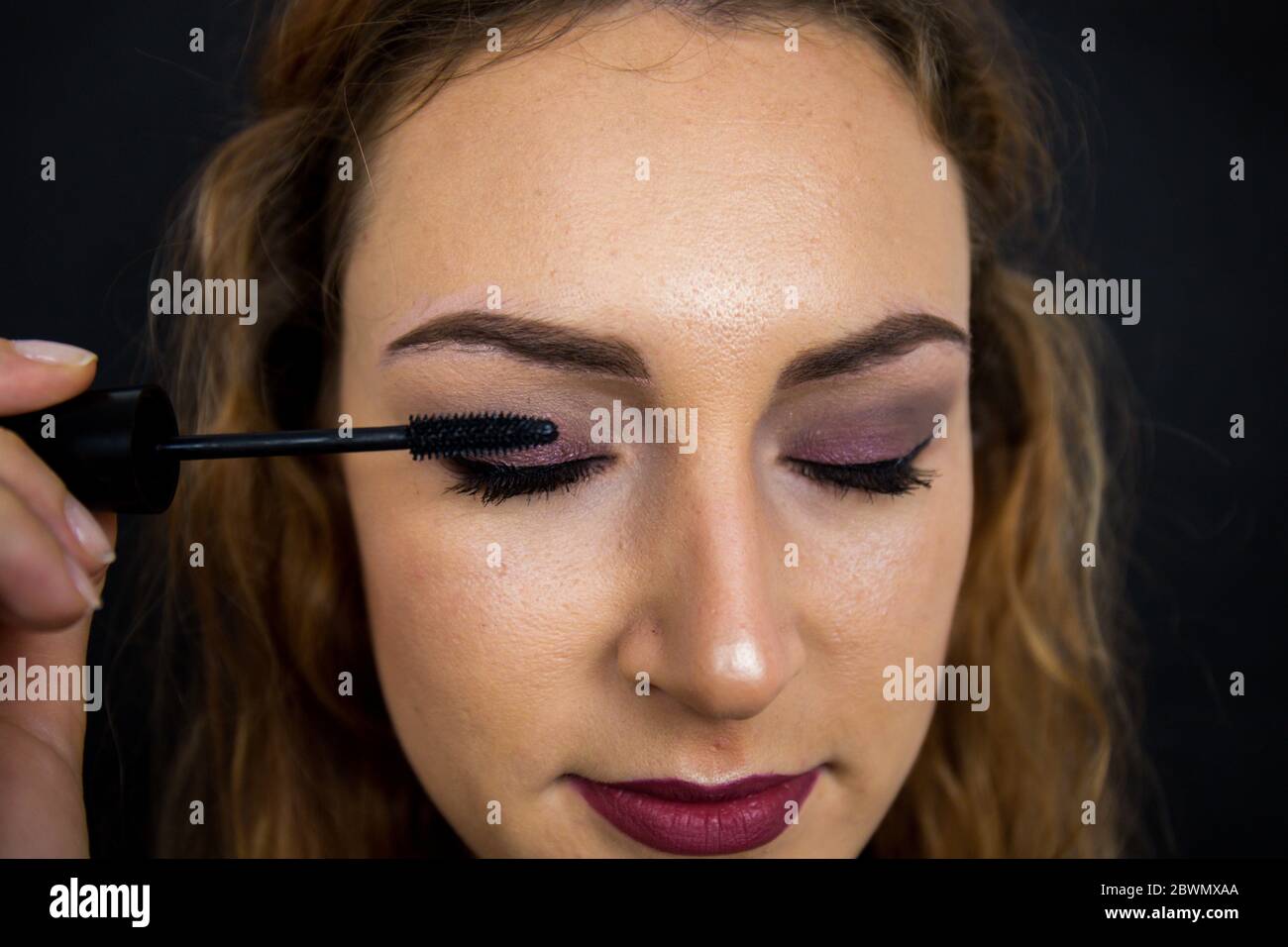 Portrait, beautiful girl, make-up, with smile posing on black ...