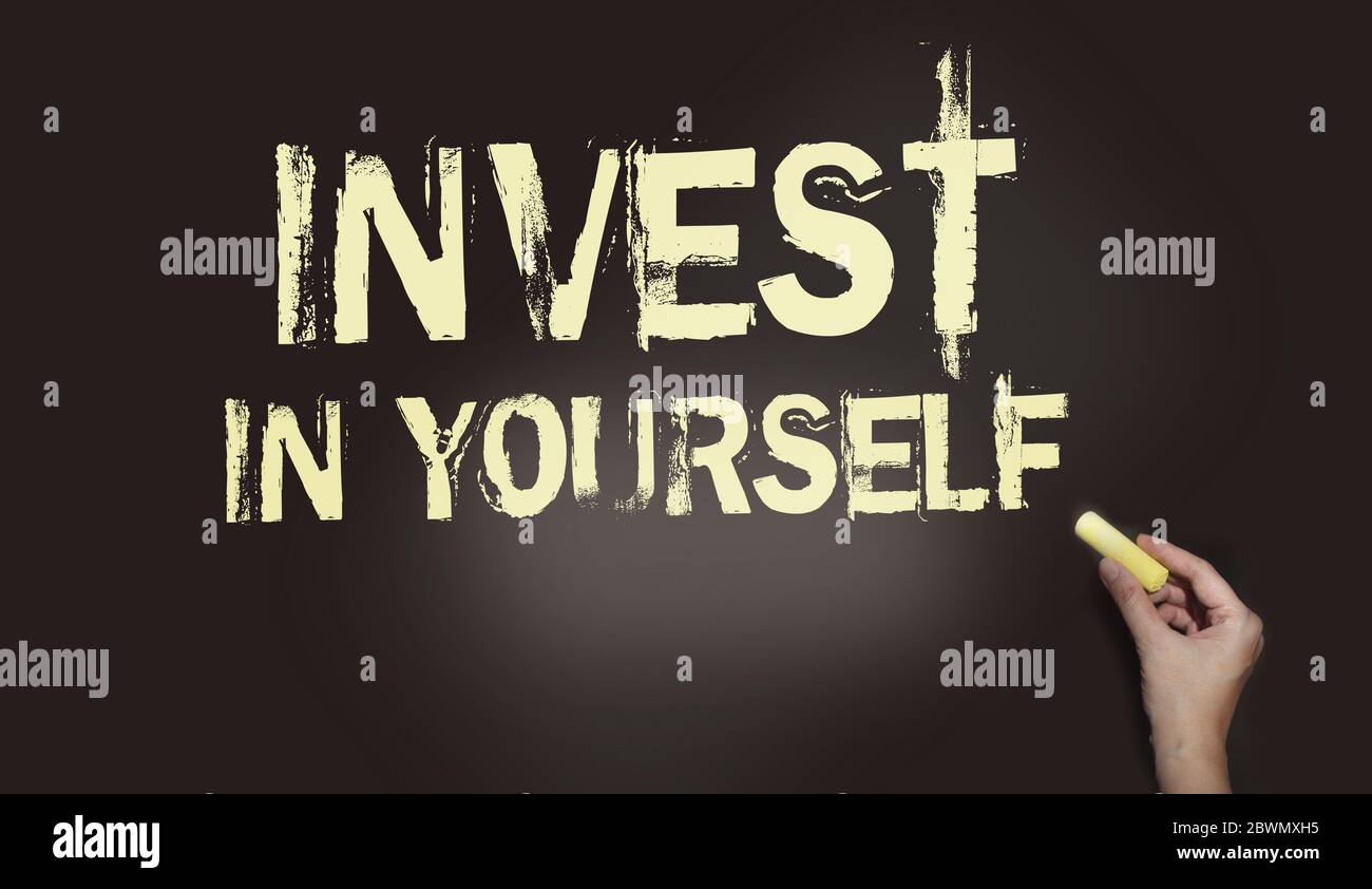 Invest in Knowledge writing, written with Chalk on Blackboard ...