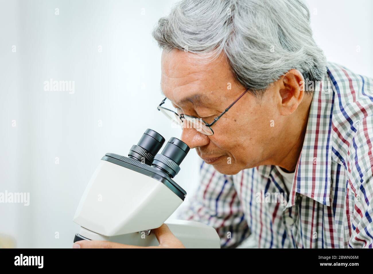 Asian Chinese doctor looking at microscope for Virus medical science ...