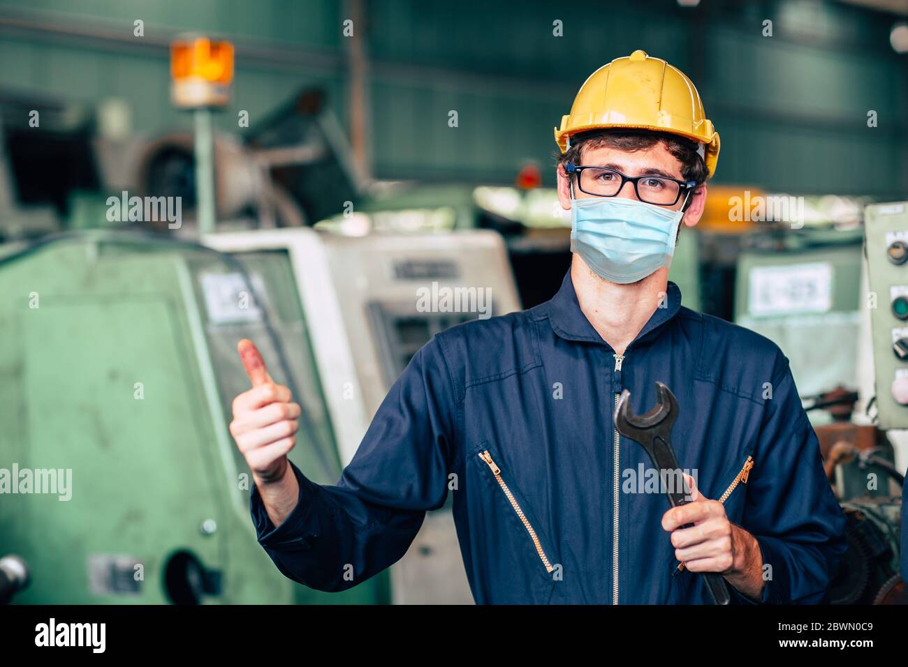 American Young Worker wear disposable face mask or HEPA face shield for ...