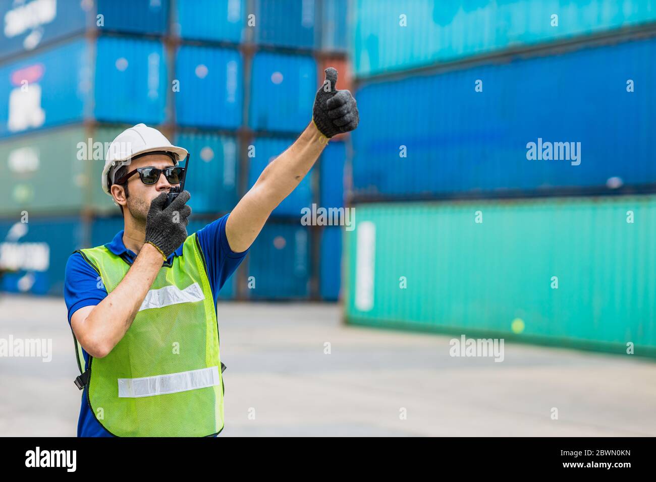 Foreman shipping staff worker working to control loading cargo port ...
