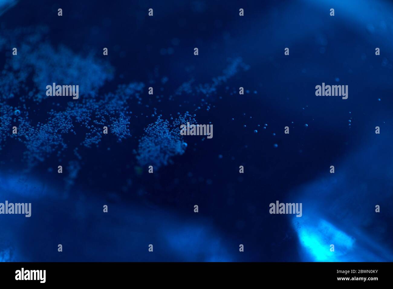 Blue sparkling water with ice cubes and bubbles macro close up Stock ...